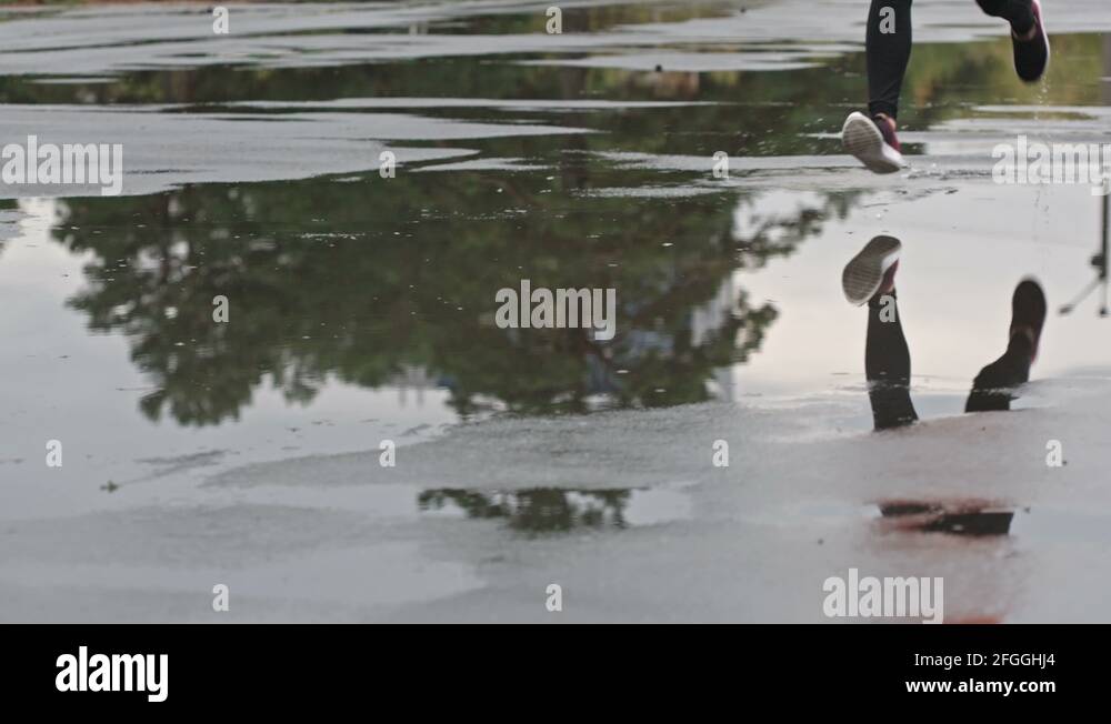 Female Legs Running Trough Puddle Stock Video Footage - Alamy