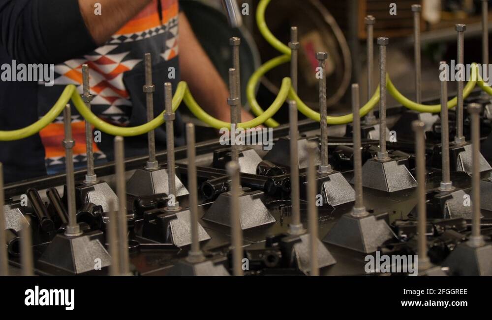 Worker putting together parts in an assembly line in a shop Stock Video ...