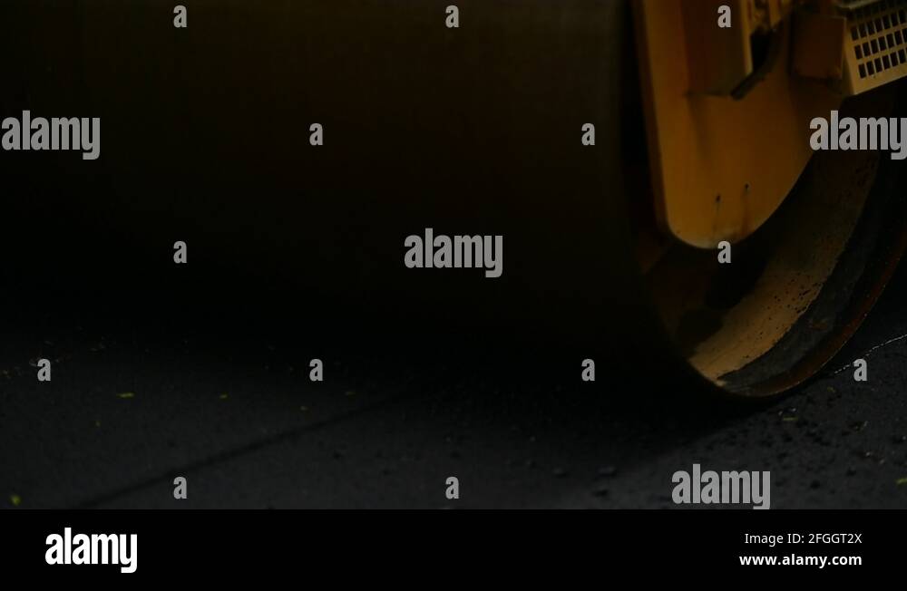 Asphalt paving with a steel wheel roller. Steam coming out from asphalt ...