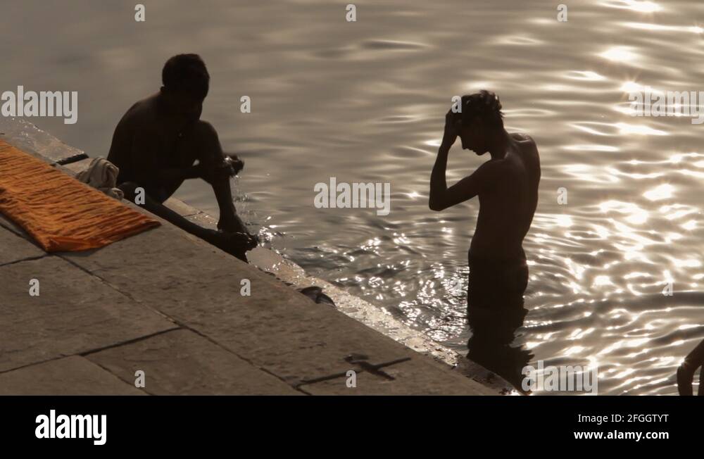 WS HA Silhouette of two boys bathing in Ganges River / Varanasi, India ...