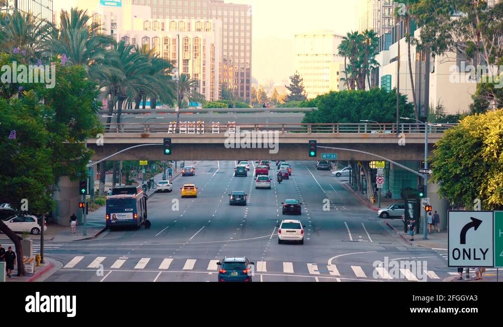 Traffic and people cross at a busy intersection in Downtown LA Stock ...