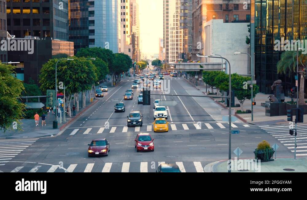 Traffic and people cross at a busy intersection in Downtown LA Stock ...