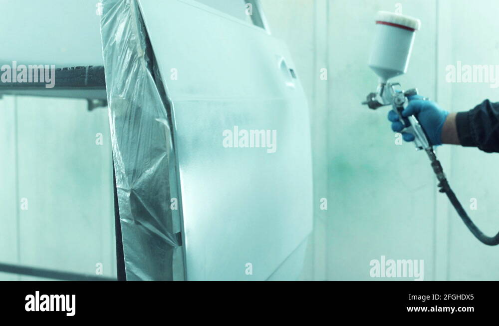 Mechanic spray painting a car in a body shop Stock Video Footage - Alamy