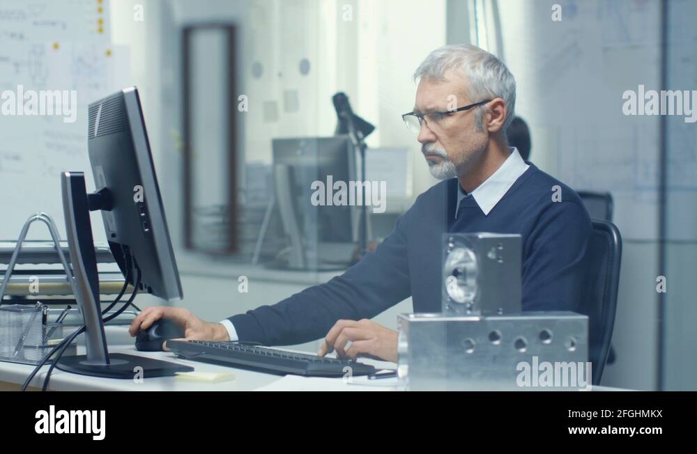 Engineering Bureau. Chief Engineer Working at His Desk, Some Technical ...