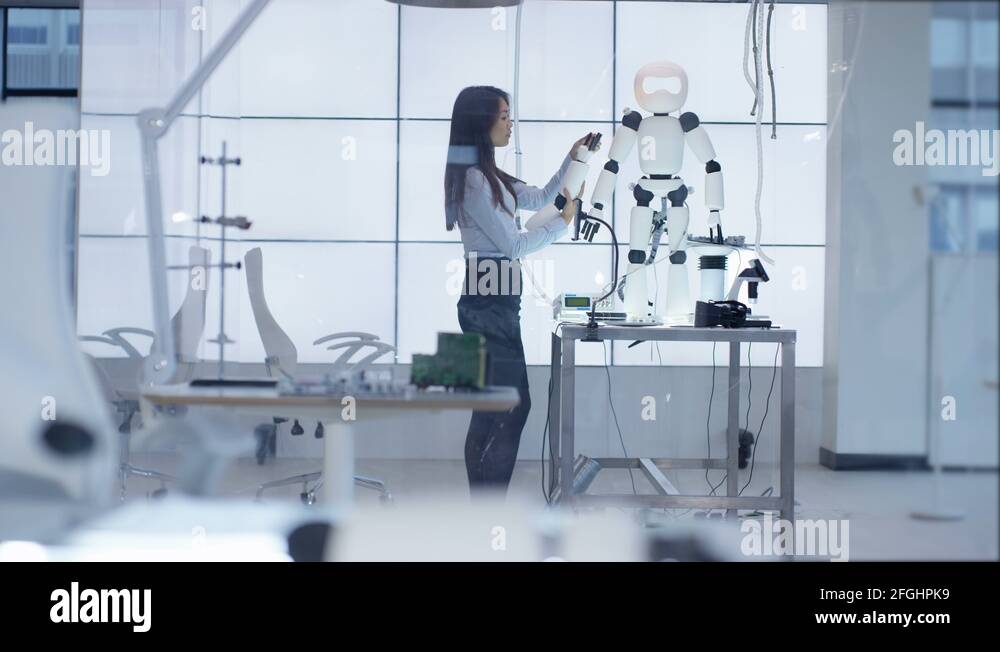 4K Technical engineer working on construction of automated robot in ...