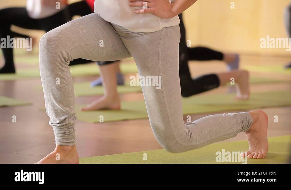 Young women swing legs. Women train muscles of legs. In the special ...