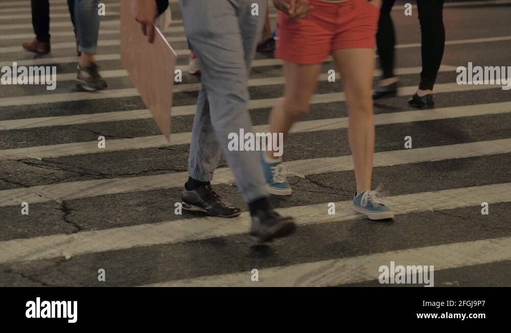 DOF: Detail of human legs walking on crowded pedestrian crossing in the ...
