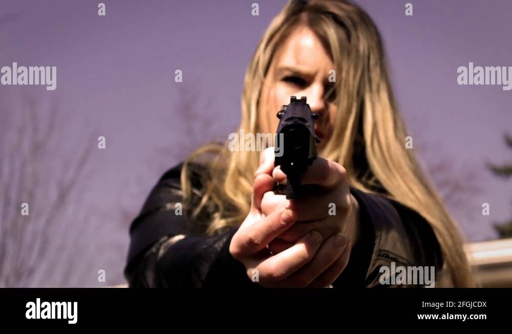 Female Secret Agent aims pistol at camera V2 Action Movie Shots Stock ...