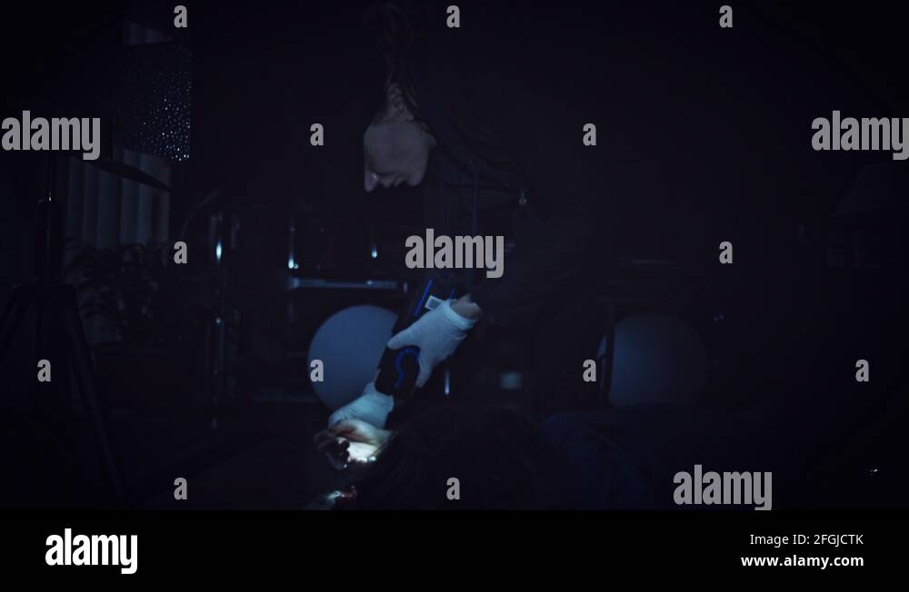 4K Crime Scene Detective Examines Dead Body with Flashlight Stock Video ...