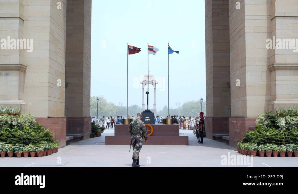 Soldier with gun, royal guard, India Gate war memorial, windy day, New ...