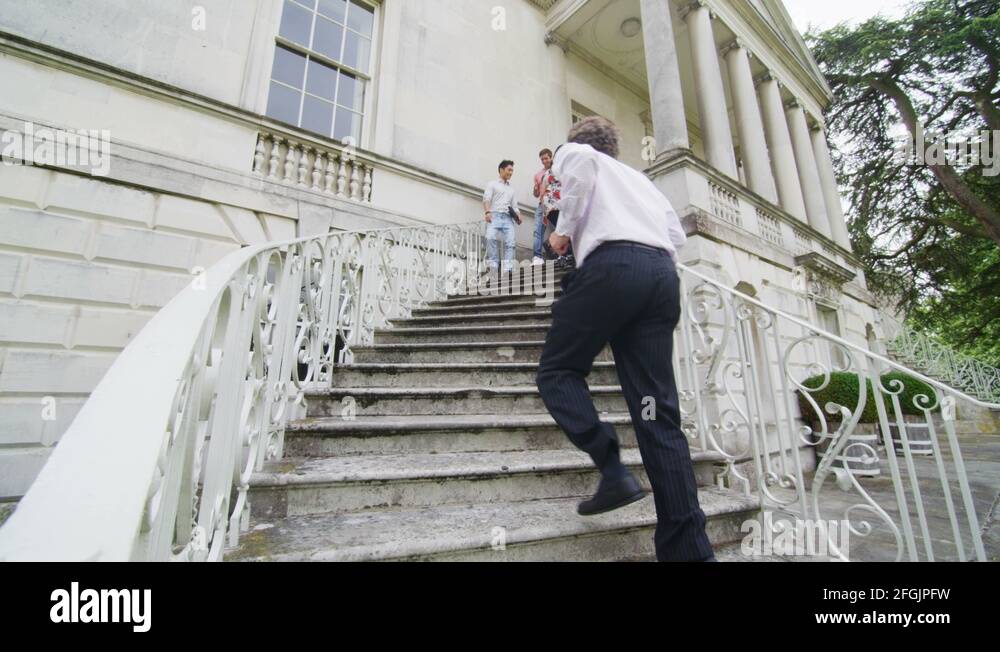 4K Diverse group students & teachers using staircase outside university ...