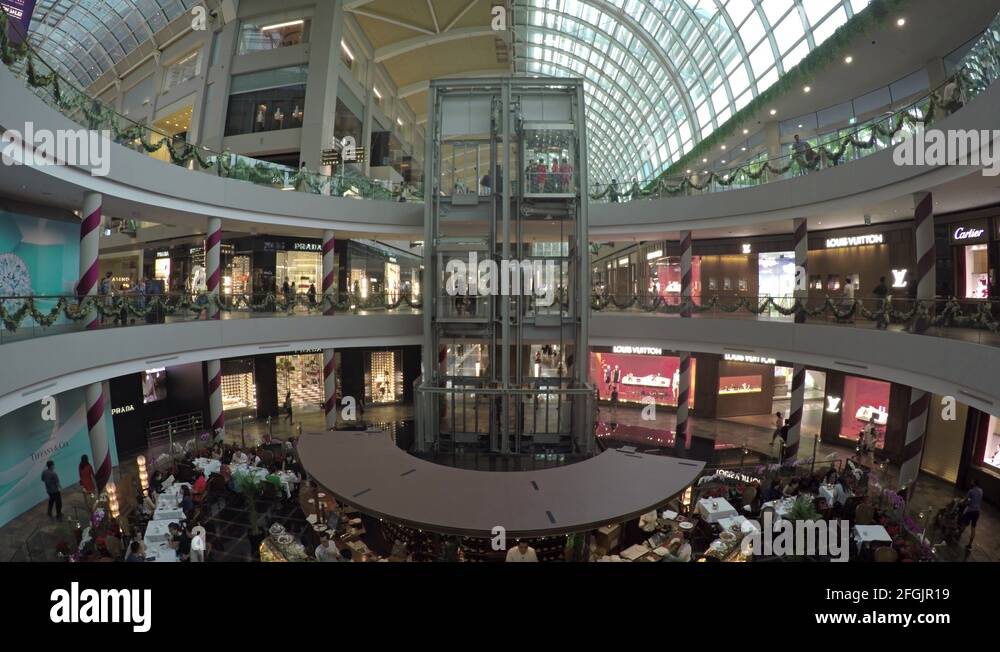 Glass Elevators over an Atrium Restaurant at the Mall inside Marina Bay ...