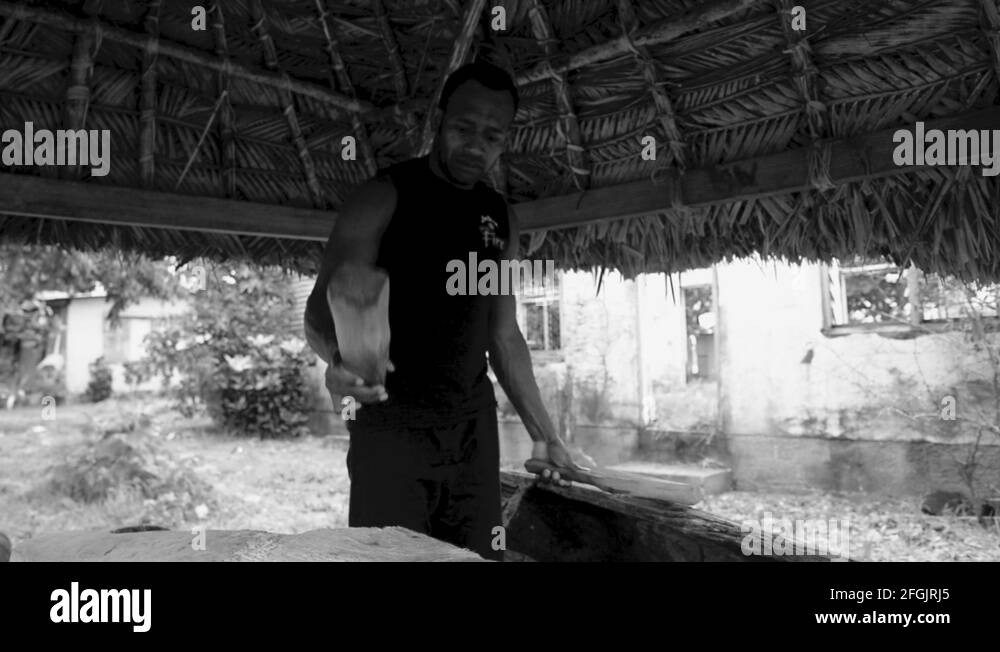 Indigenous Fijian man play on a Fijian Lali stick drum in Fiji Stock ...