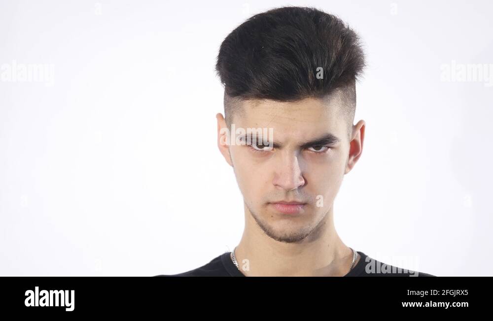 portrait of angry serious young man, boy isolated over white background ...