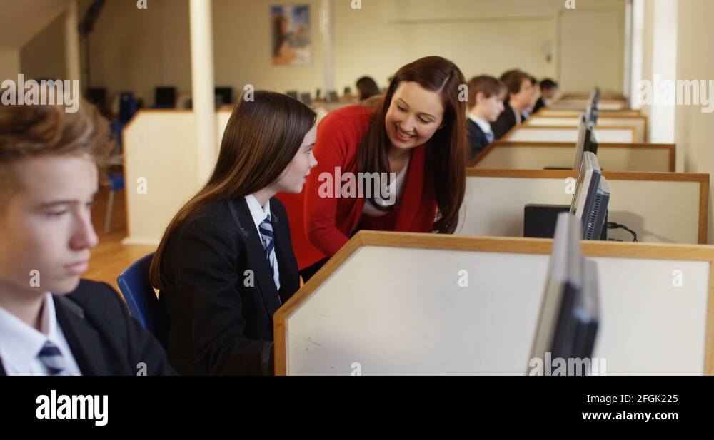 4k, Teacher with school children working in a large computer lab. Slow ...