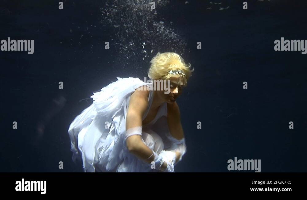 Underwater model in angel costume poses for camera in the Red Sea Stock ...
