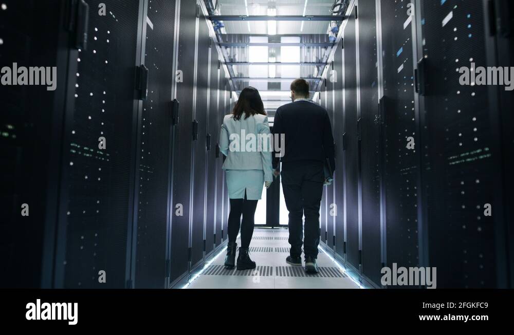 Back View of Male and Female IT Engineers Walking in Data Center Stock ...