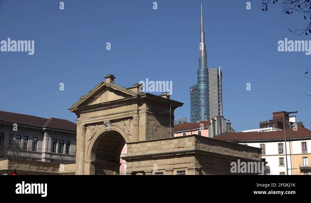 4K Ancient Milan city gate and modern building tower in crowded ...