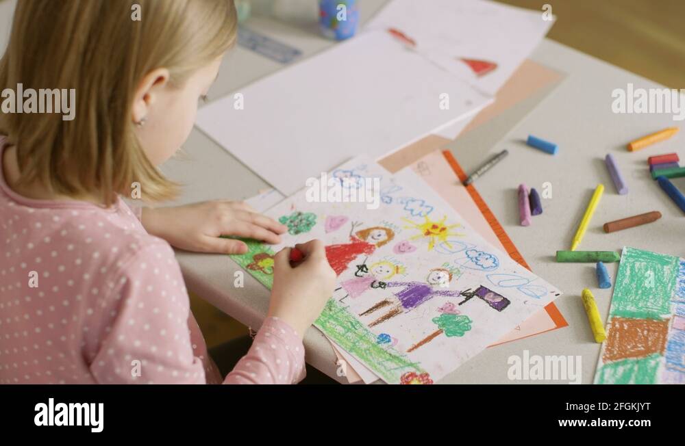 Over The Shoulder View of Cute Little Girl Drawing Her Family with ...