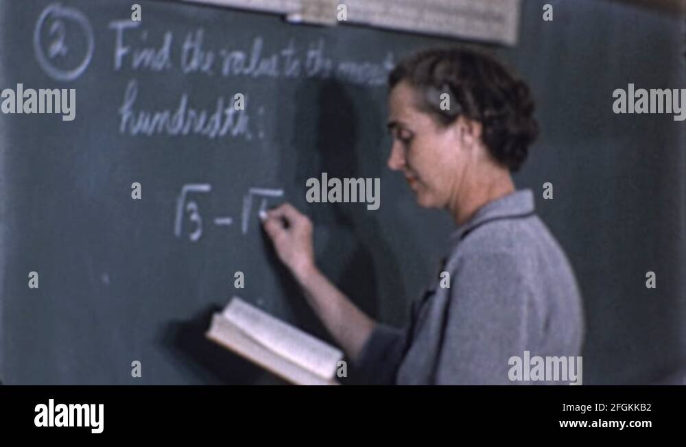 Woman Teacher Writes On Blackboard in Classroom 1950s Vintage Film ...