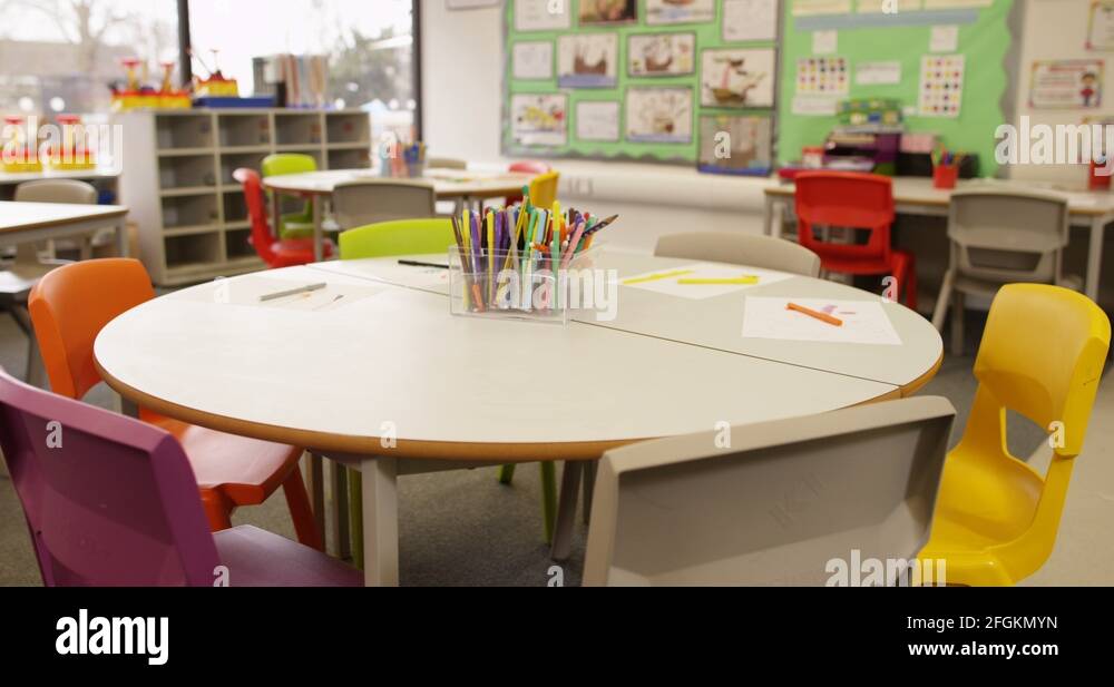 4K Empty primary school classroom with pens & children's drawings on ...