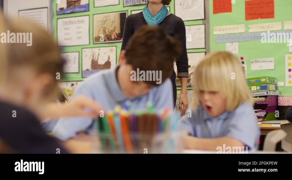 4k, Elementary children and their teacher in a lesson at school. Slow ...