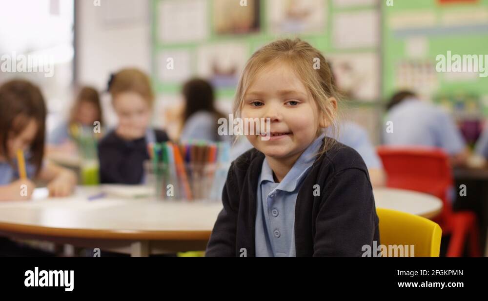 4k, Portrait of a cute smiling girl learning in classroom. Slow motion ...