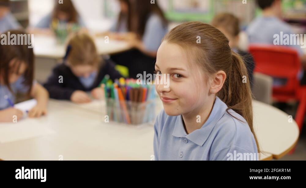 4K Portrait cute smiling little girl in primary school classroom Stock ...