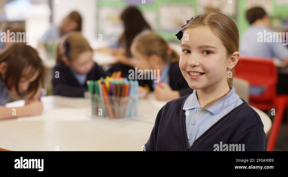 4K Portrait cute smiling little girl in primary school classroom Stock ...