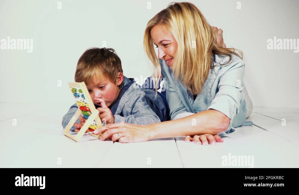 Mother and son learning to calculate with a calculating machine Stock ...