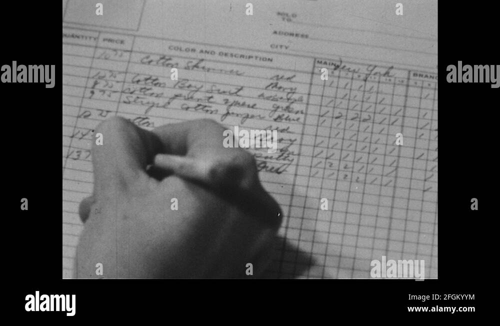 1950s: A man writes in a ledger. An early computer display with ...