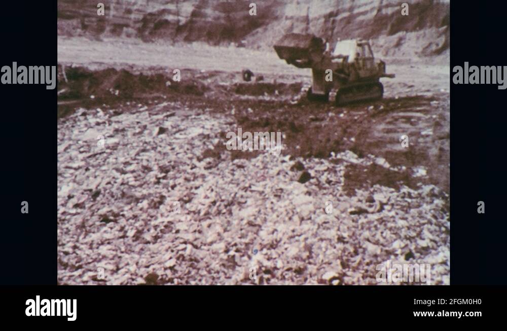 1970s: Vehicle empties oil on top of rubbish in landfill site Stock ...
