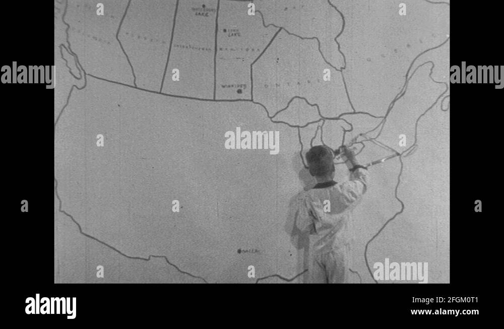 1950s: Boy paints line on map, man bursts head through map, boy takes ...