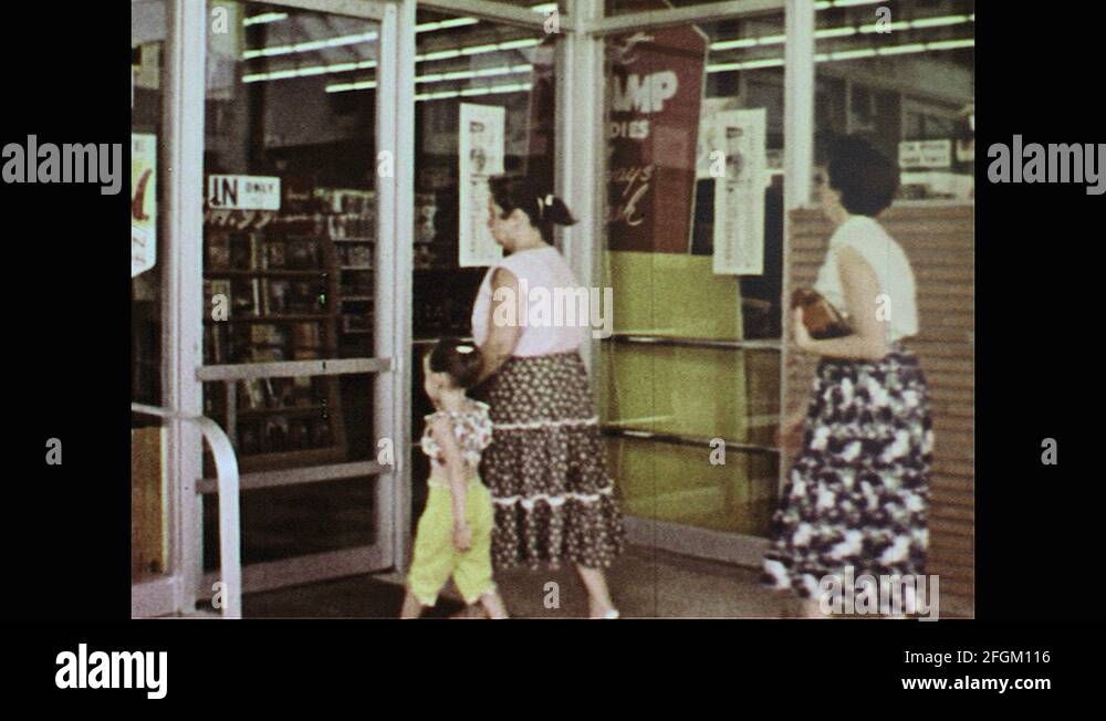 1950s: Customers enter store / Woman enters store, meets man and boy ...