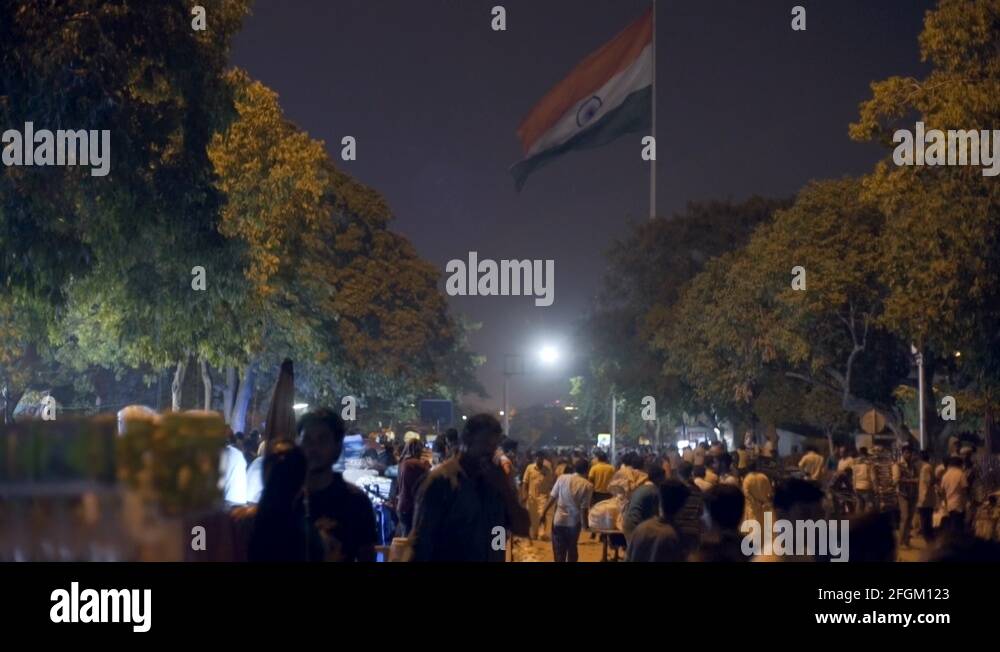Huge India flag, crowd of people, nighttime market, Connaught Place ...