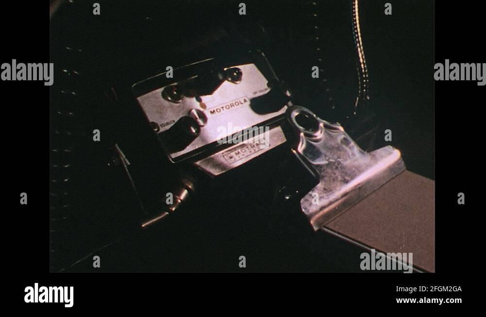 1970s: Close up of police radio / Car interior, police officer driving ...