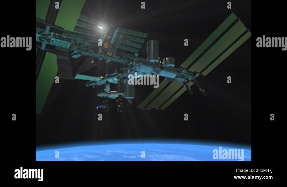 1990s: CGI animation of international space station in orbit. It angles ...