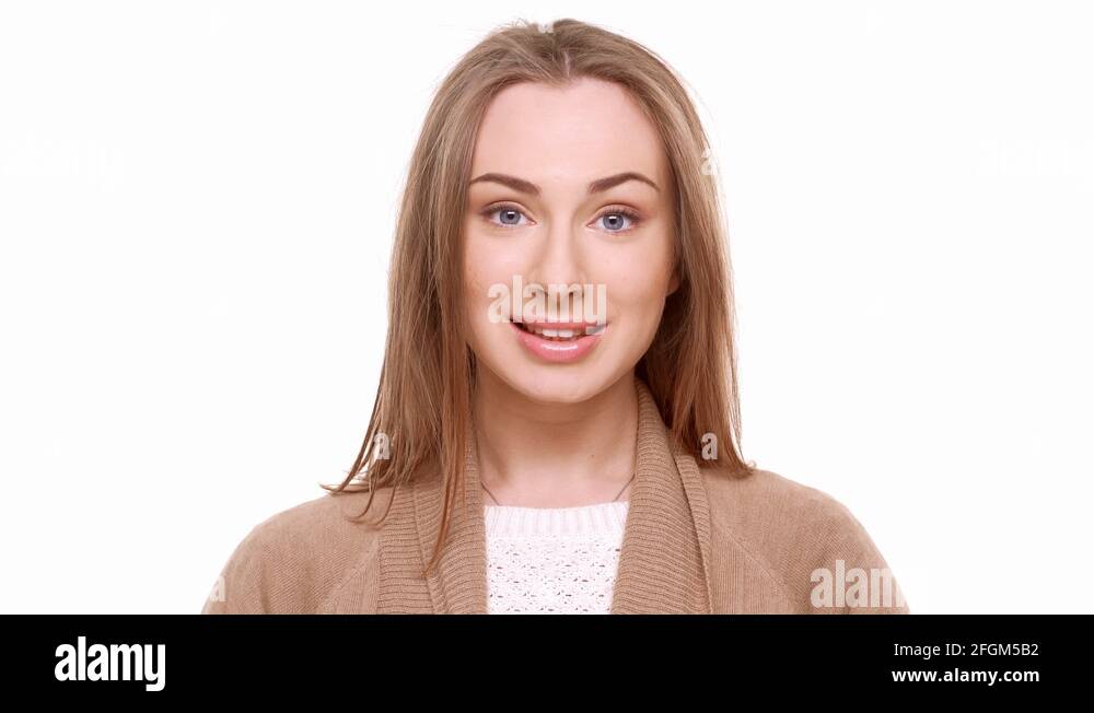 Confused Caucasian young female with light brown hair standing shy on ...