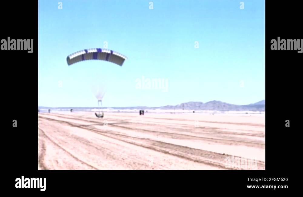 1990s: A space shuttle with a parachute attached touches down on a ...