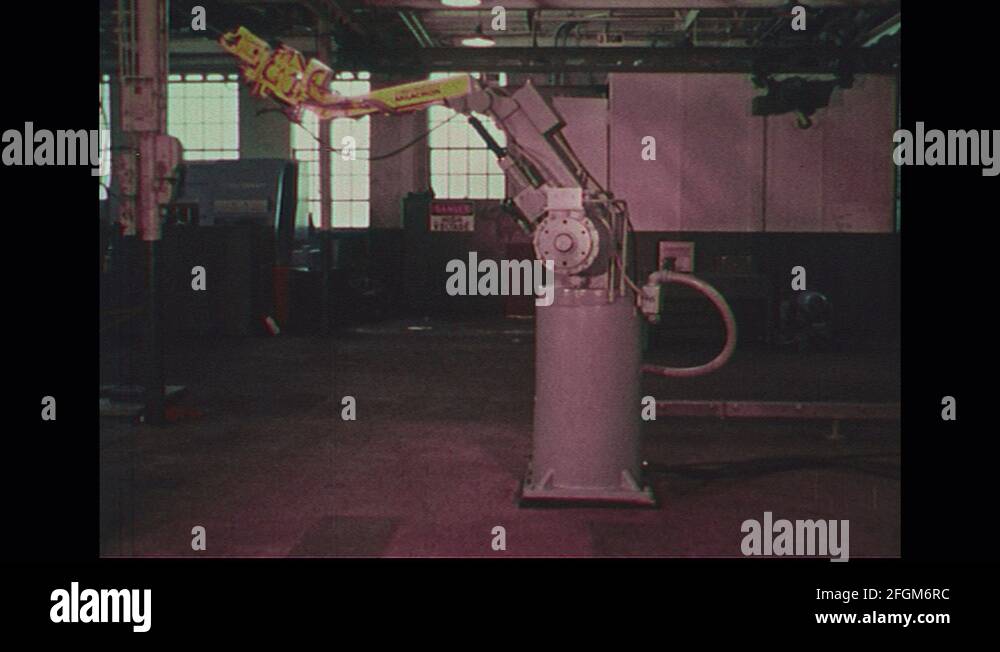 1980s: industrial robotic arm shows range of motion. CNC mini computer ...