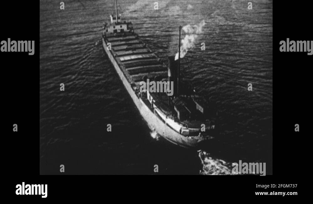 1940s: A cargo ship travels the seas and docks by a port for materials ...