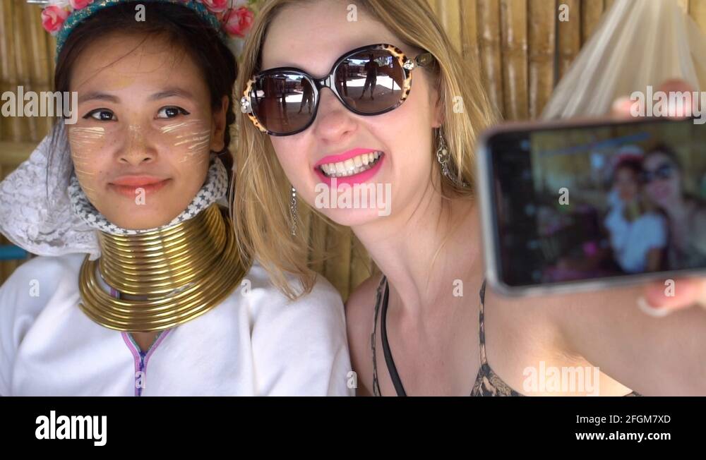 Tourist taking selfie photos with a Long Neck woman in traditional ...
