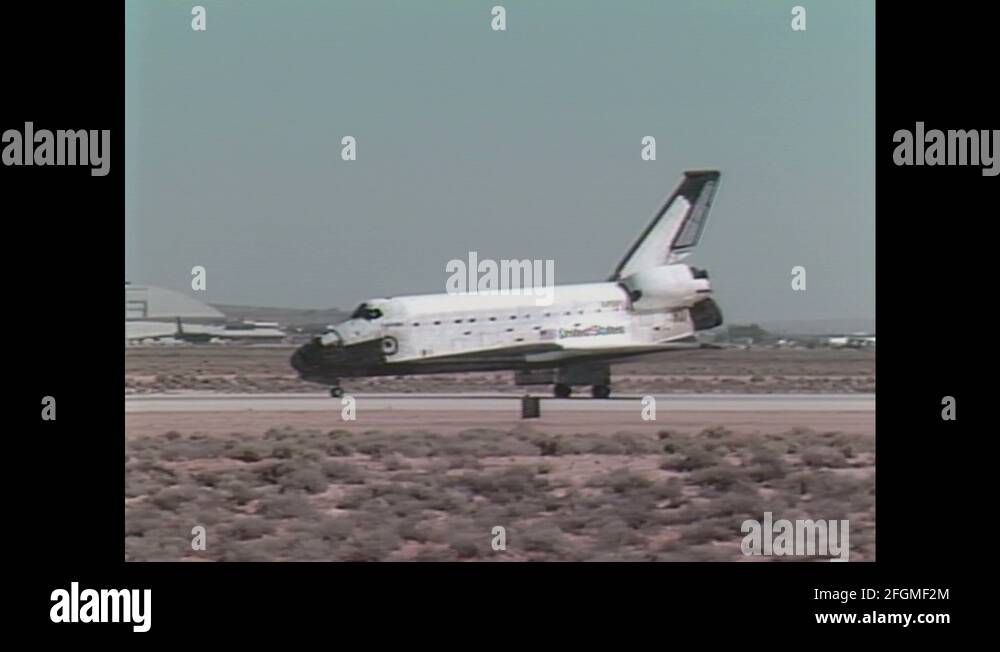 1990s: space shuttle on runway. Astronaut stands inside space shuttle ...