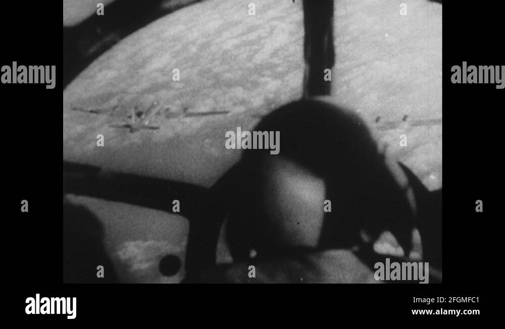 1940s: view through window as pilot flies plane in war. View through ...