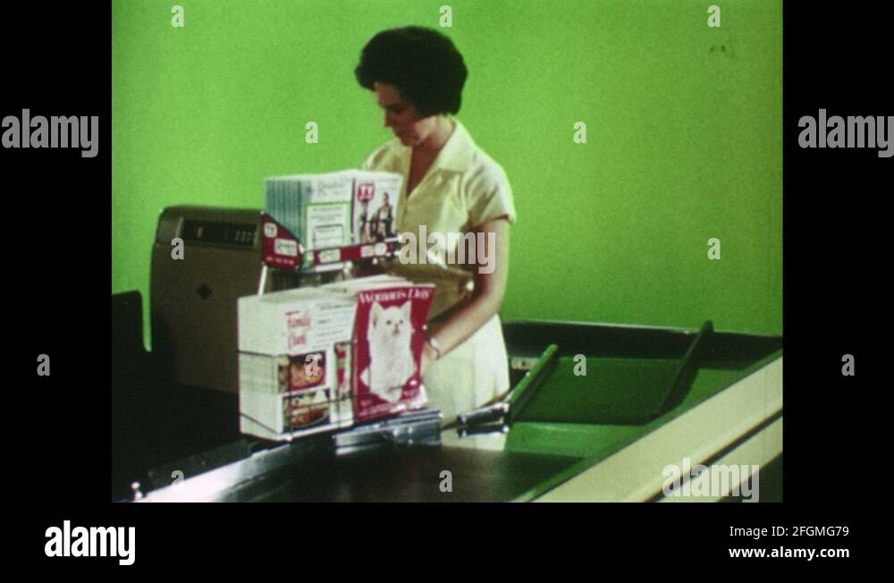 1960s: Lady at check out till prepares register for customers. Lady ...