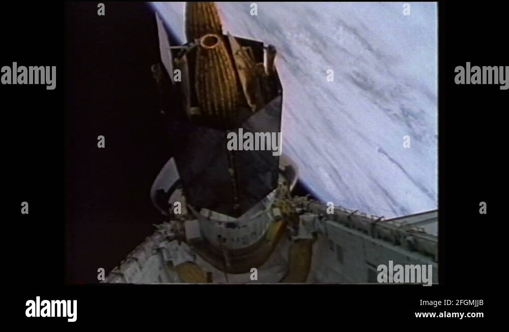 UNITED STATES: 1980s: satellite attached to space shuttle in space ...