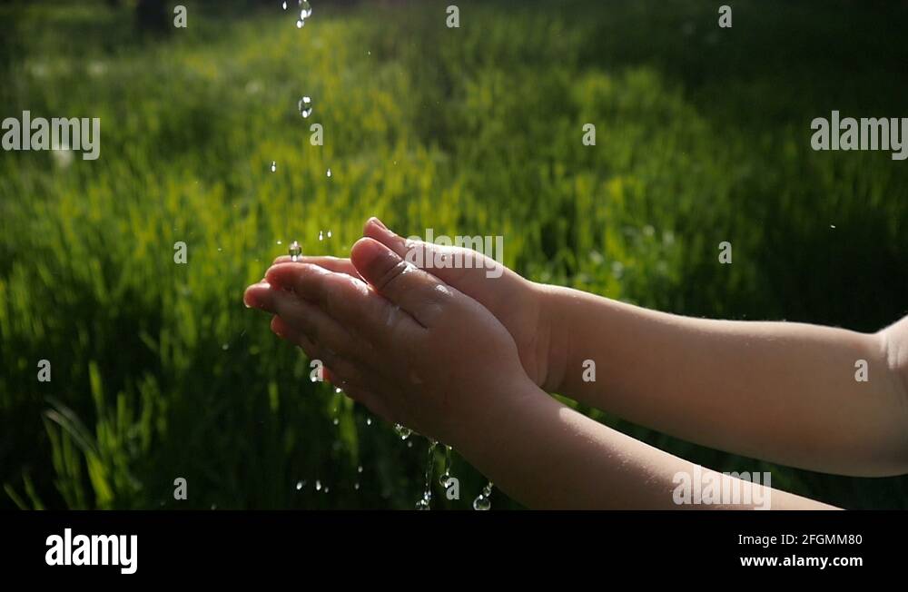 Dripping water falling drops jet washing hands of little child girl ...