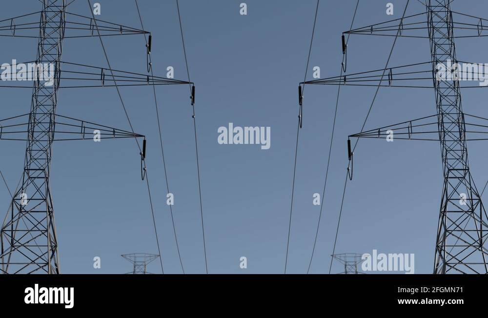 Electricity pylons. Moving along two row of pylons. electric high ...
