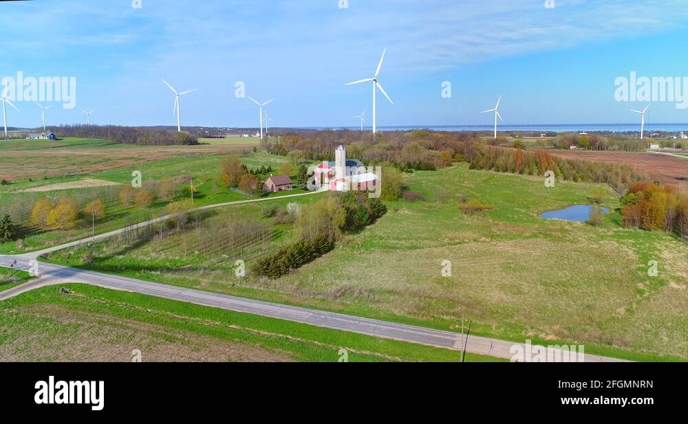 Giant wind turbines dominate the landscape, dwarfing farms and silos ...