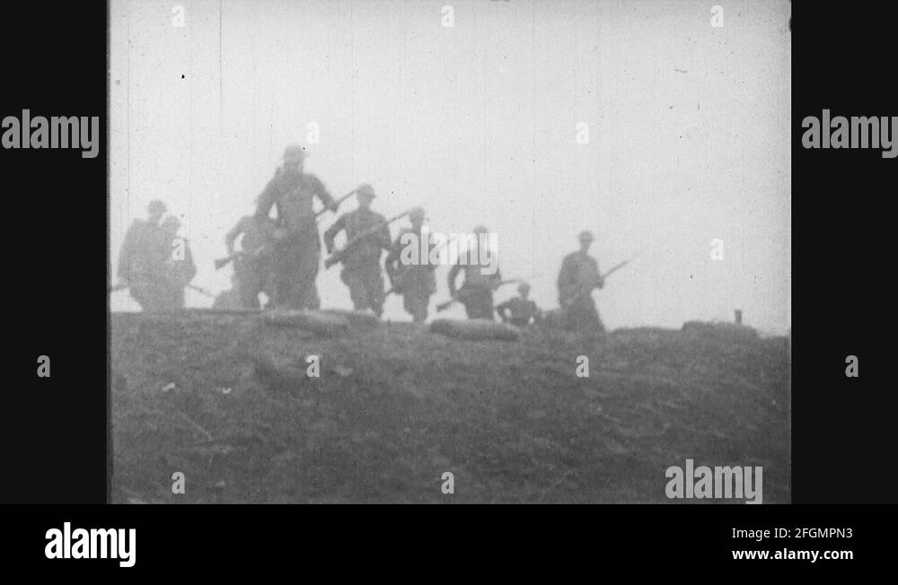 UNITED STATES: 1910s: soldiers run across ground. View from above ...